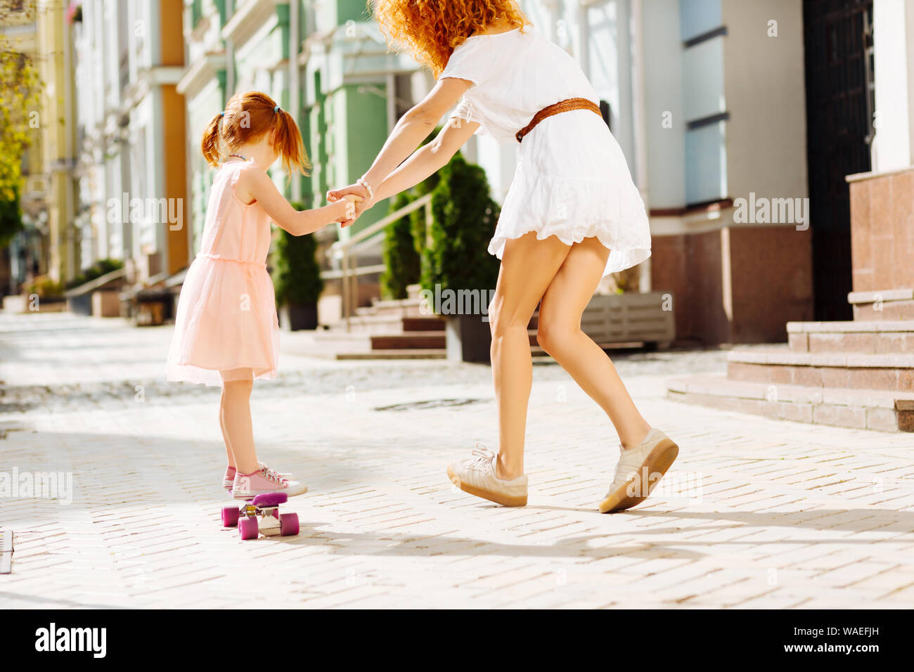 Attentive red haired little girl looking forward Stock Photo - Alamy