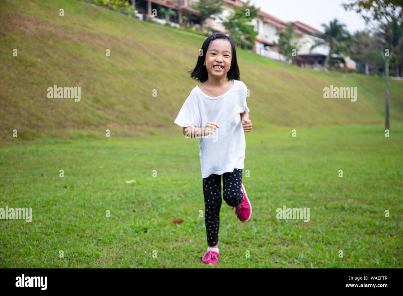 Asian Little Chinese Girl running happily at the outdoor park Stock ...