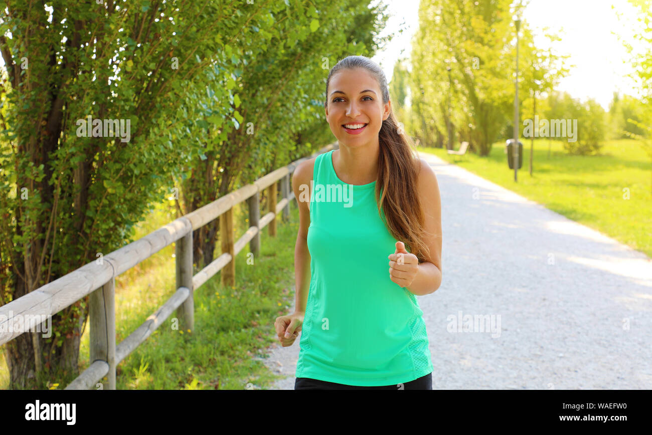 Running woman. Female runner jogging during outdoor workout in a Park ...