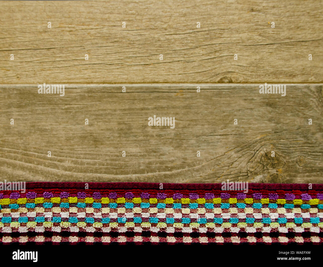 Plan view of a colorful towel laying on a ground of wood with texture ...