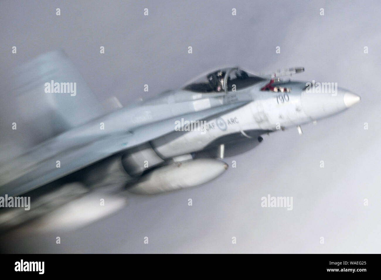 A Royal Canadian Air Force CF-18 Hornet drops behind a CC-150 Polaris ...