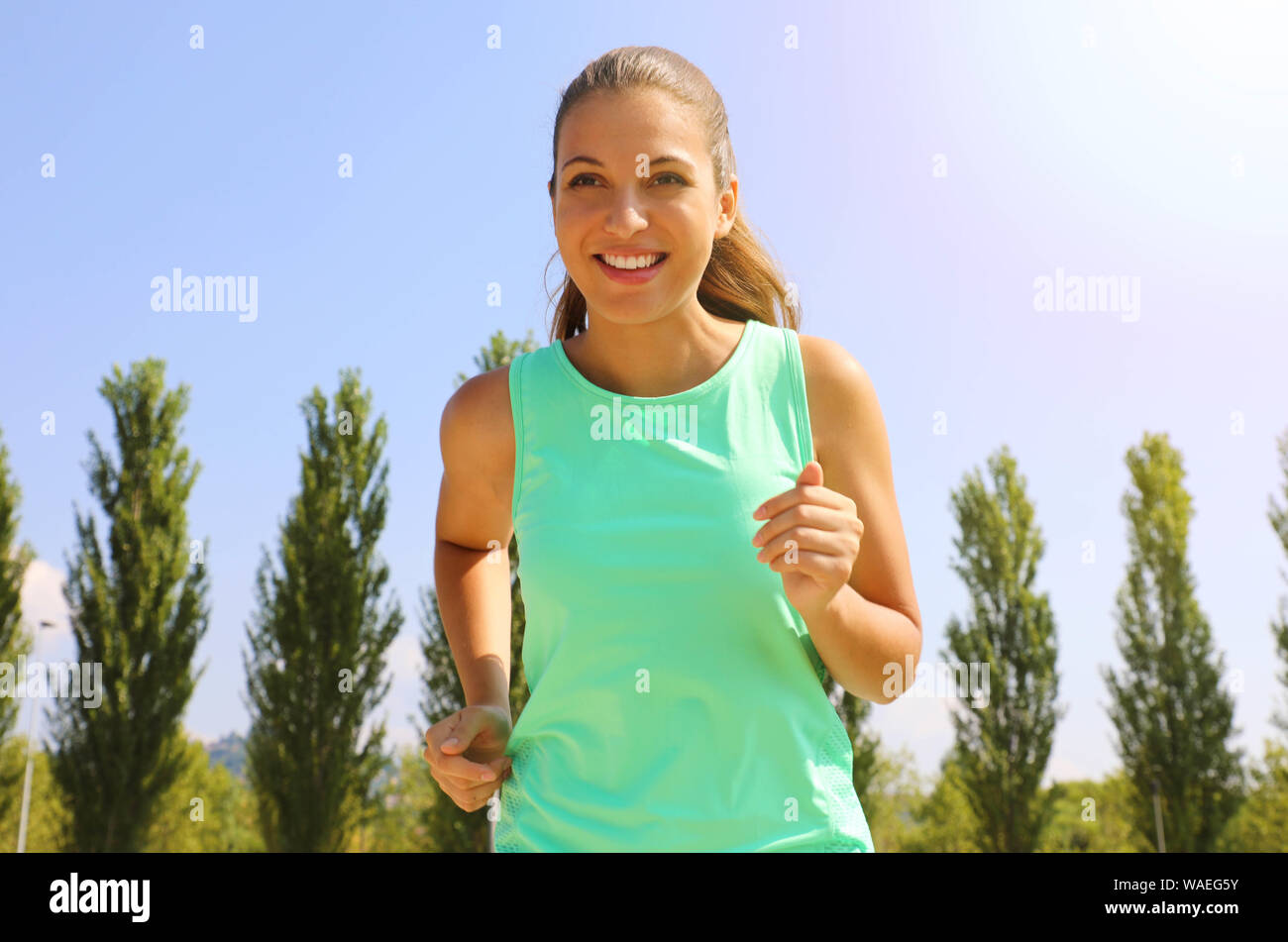 Running woman. Female runner jogging during outdoor workout in the park ...