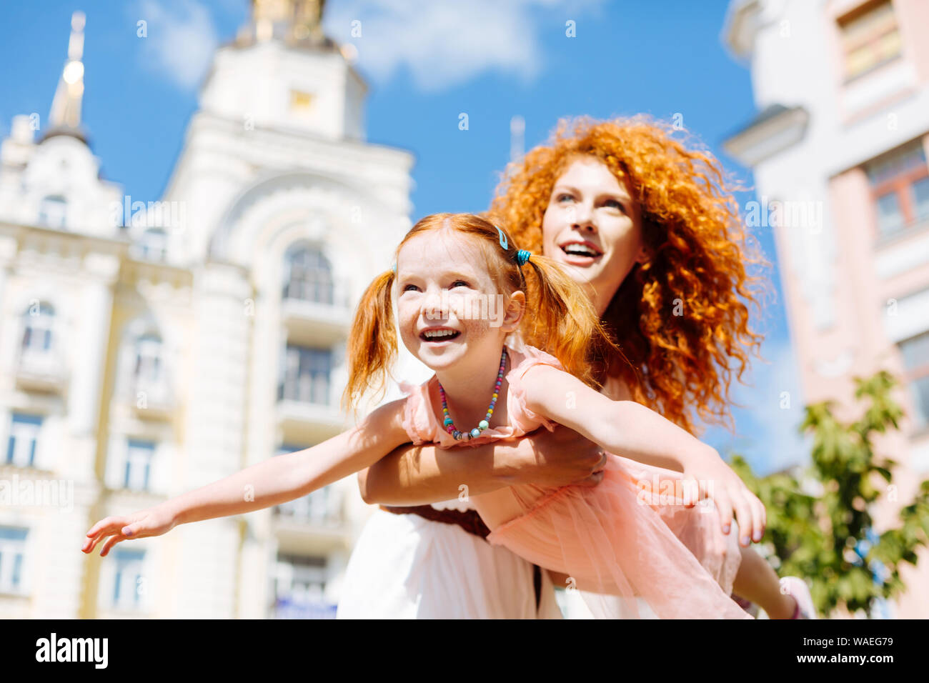 Delighted mom and kid spending day together Stock Photo - Alamy