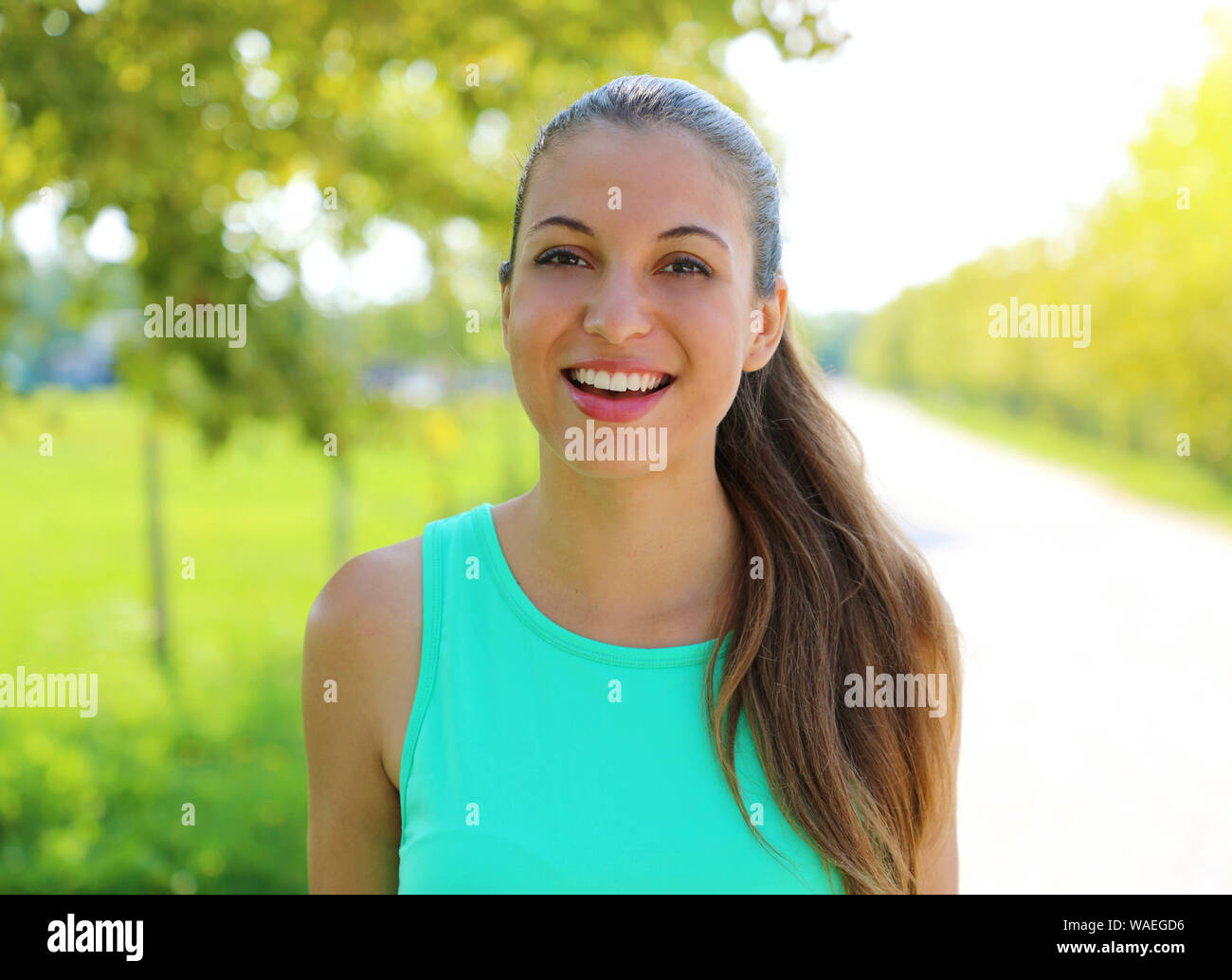 Brazilian smiling woman with a perfect white smile outdoor in the park ...
