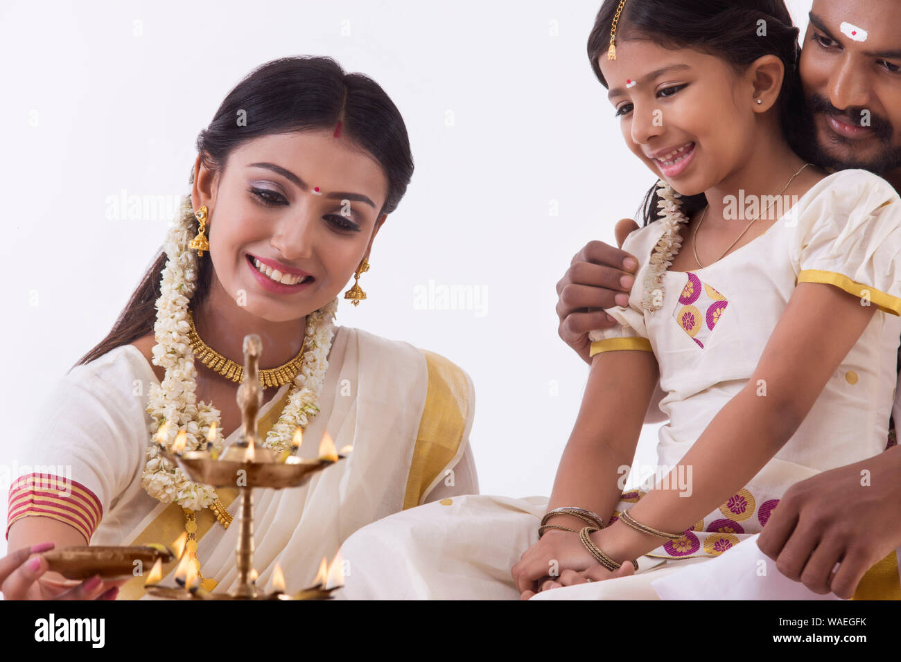 Woman lighting lamp diya hi-res stock photography and images - Alamy