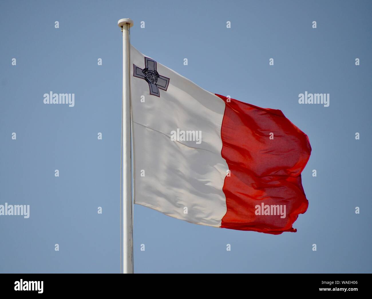 the red and white flag of malta flying in valetta Stock Photo - Alamy