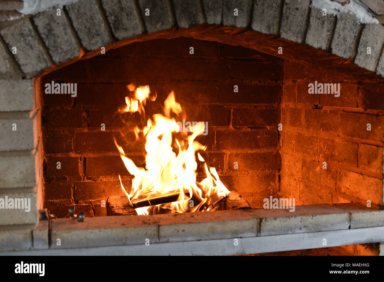 Fire wood burning in the oven. Fire in a stone stove. The stove on the ...