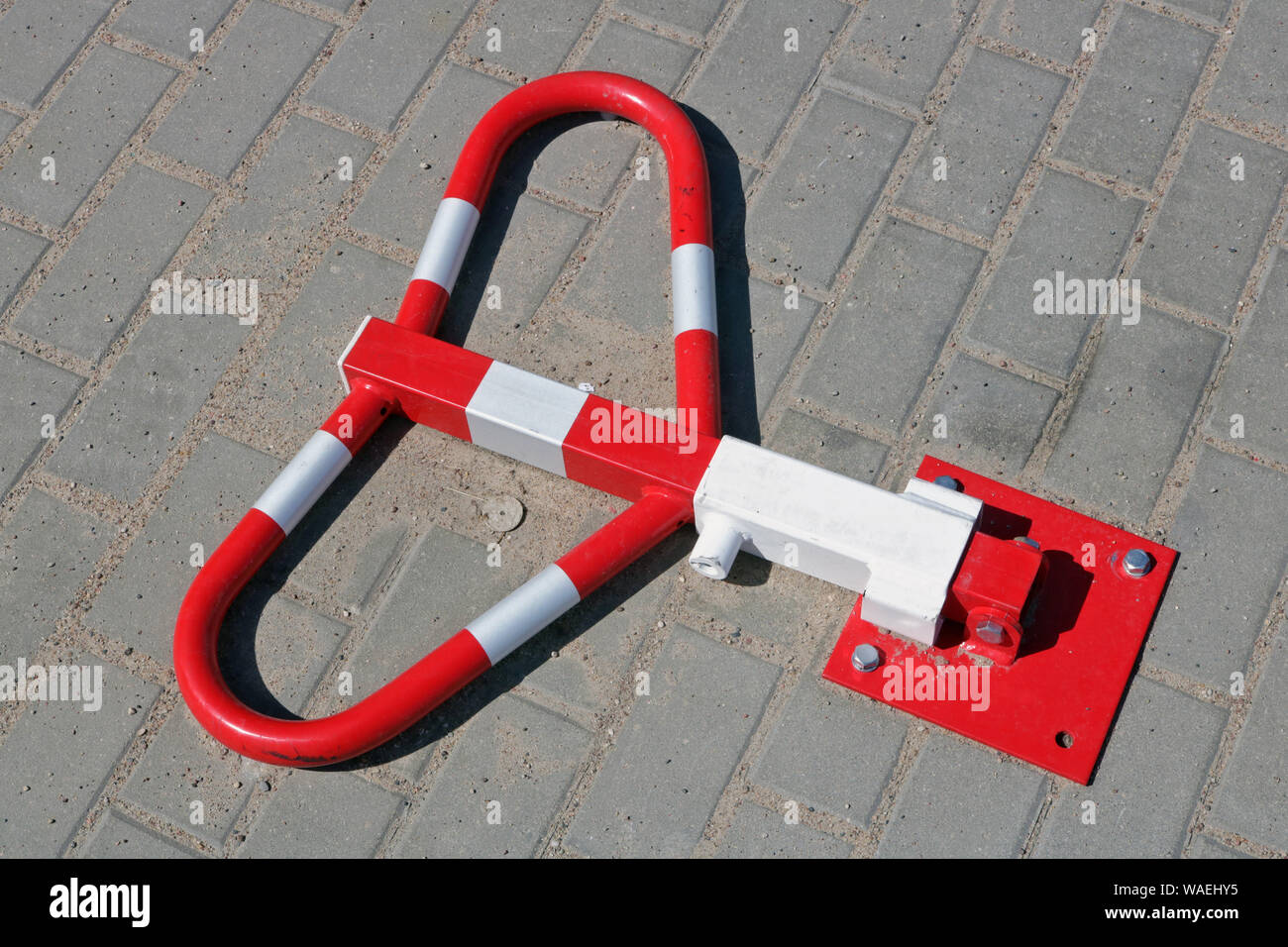 Metal red stopper lock in private car parking made from steel pipes ...