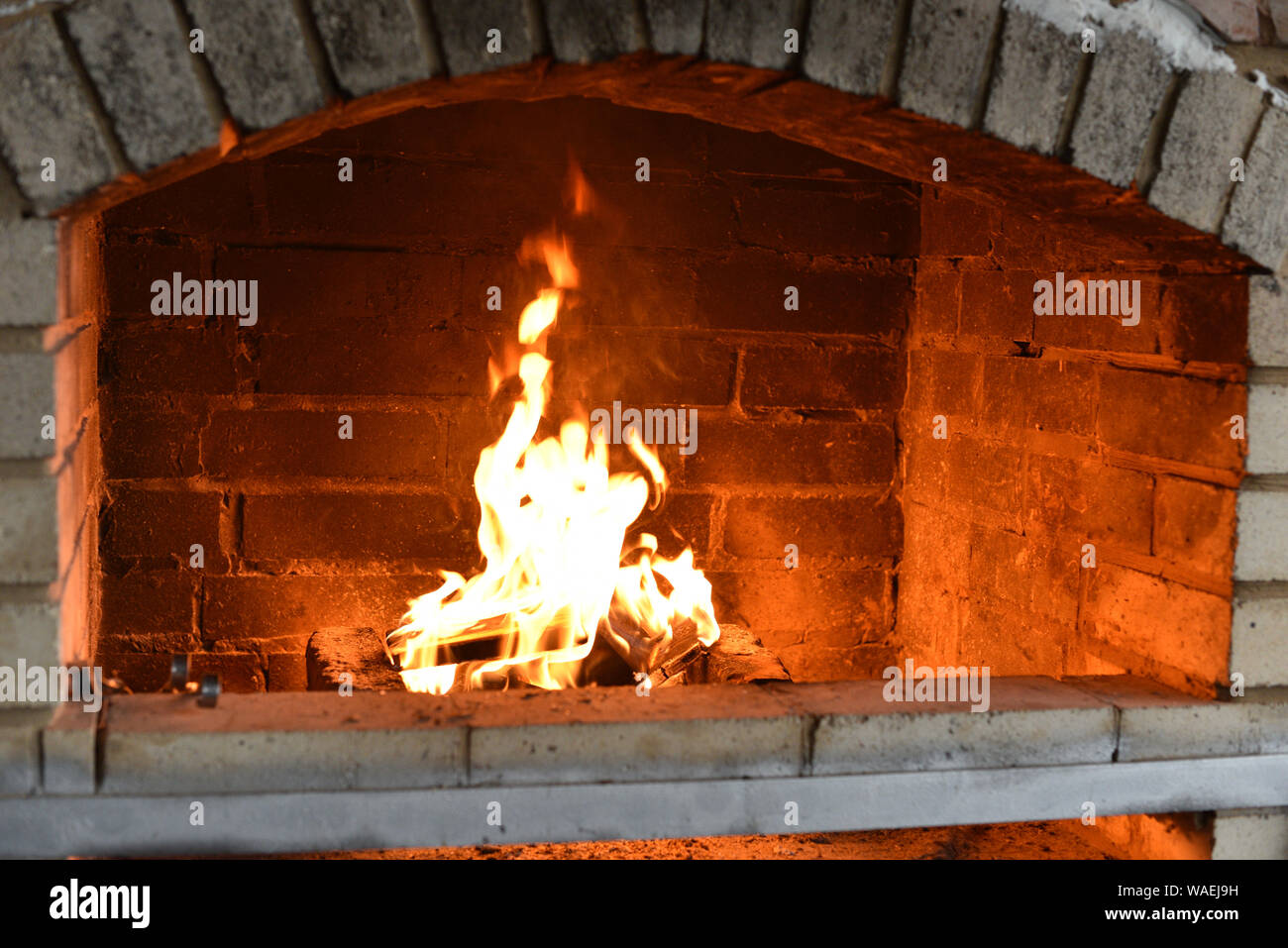 Fire wood burning in the oven. Fire in a stone stove. The stove on the ...