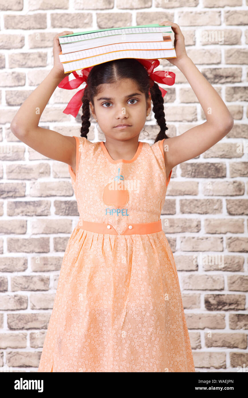Indian girl carrying books on hi-res stock photography and images - Alamy