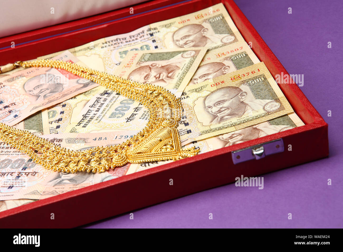 Gold jewelry on banknotes Stock Photo - Alamy
