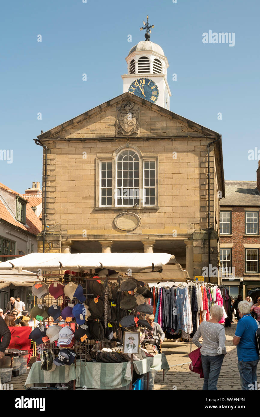 People shopping in Whitby market place and the Old Town Hall, North ...