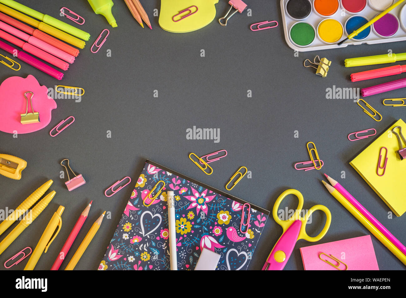 Colorful school supplies on dark background, back to school concept ...
