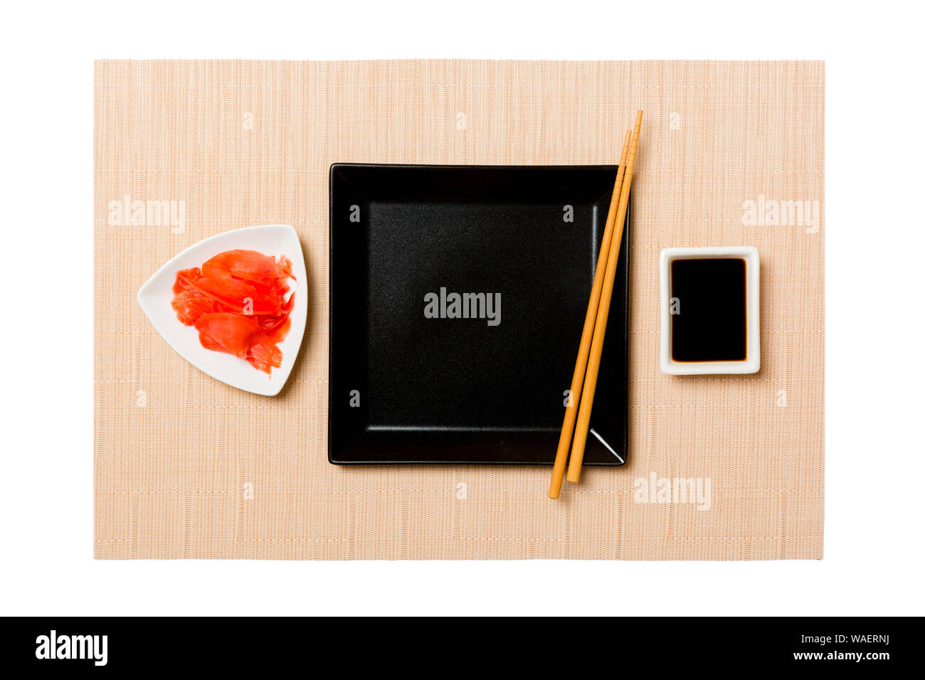 Empty black square plate with chopsticks for sushi, ginger and soy ...