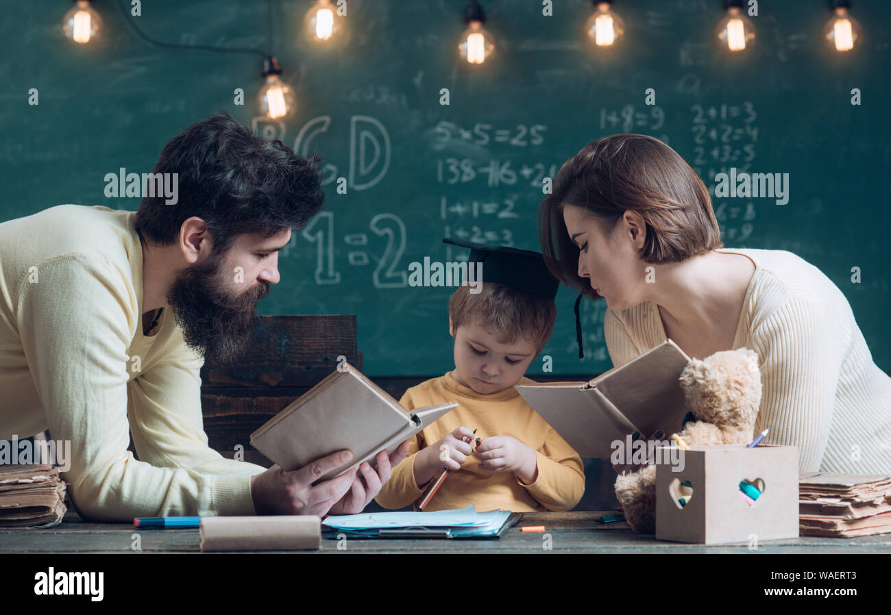 Grammar lesson. Little boy learn grammar in classroom. Mother and ...