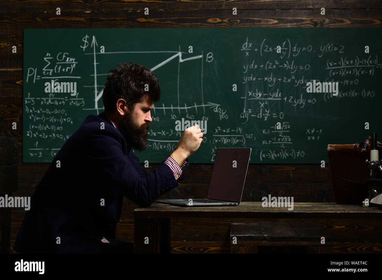 E-Learning concept with student holding his modern laptop computer ...