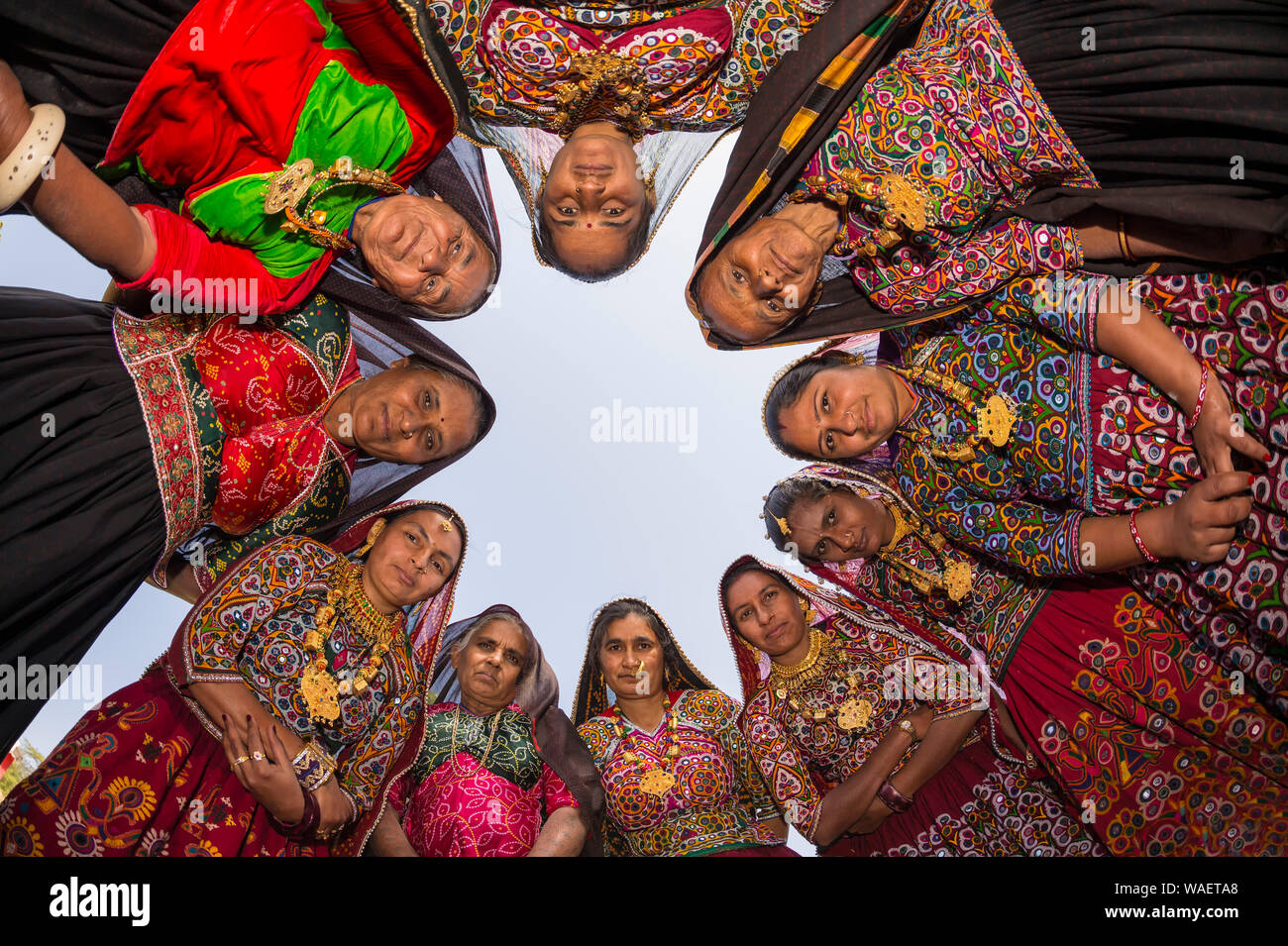 Group of Ahir Women in traditional colorful cloth looking down with ...