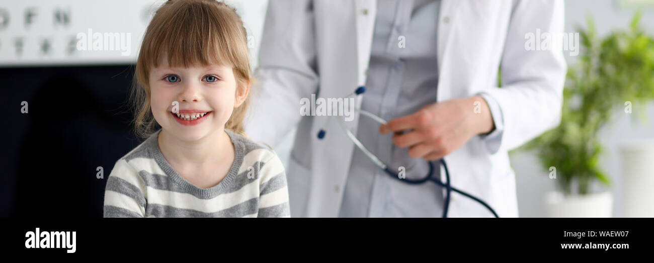 Smiling cute little patient interacting with female doctor Stock Photo ...