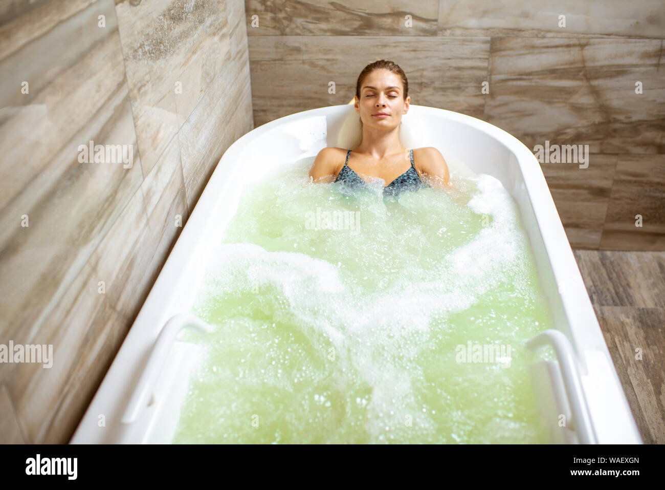 Beautiful Woman Relaxing In The Bathtub Having A Hydromassage Therapy