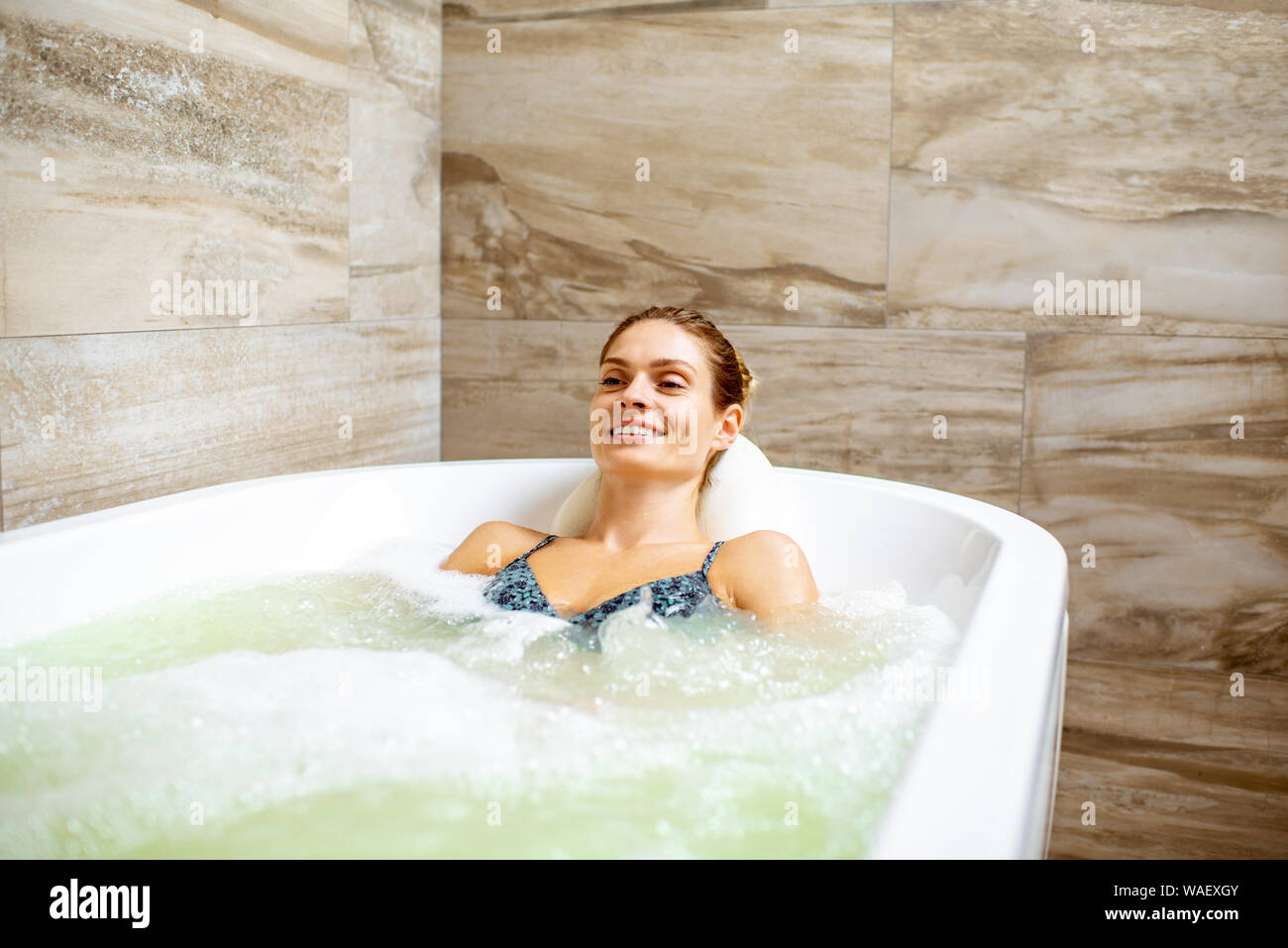 Beautiful Woman Relaxing In The Bathtub Having A Hydromassage Therapy