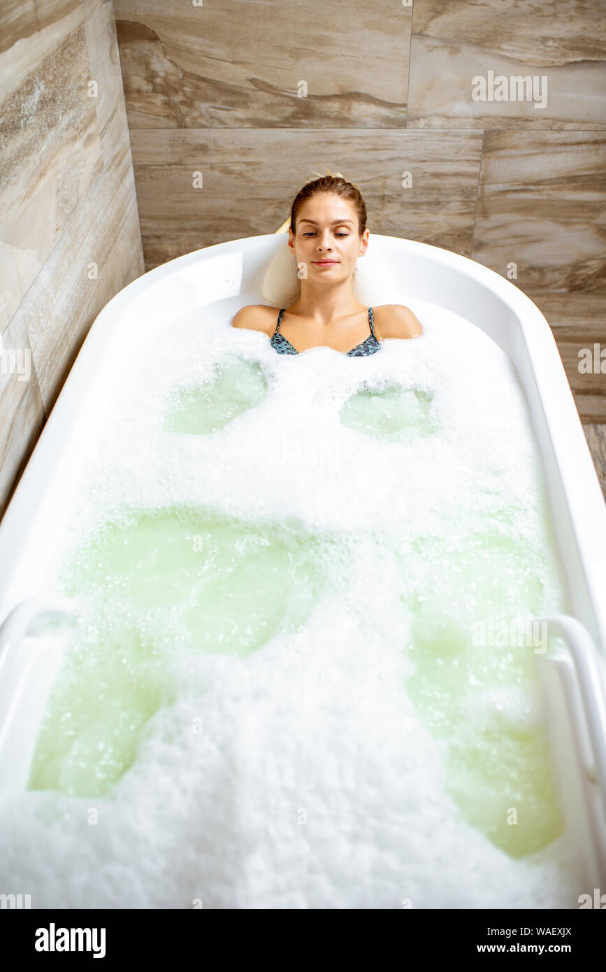 Beautiful Woman Relaxing In The Bathtub Having A Hydromassage Therapy