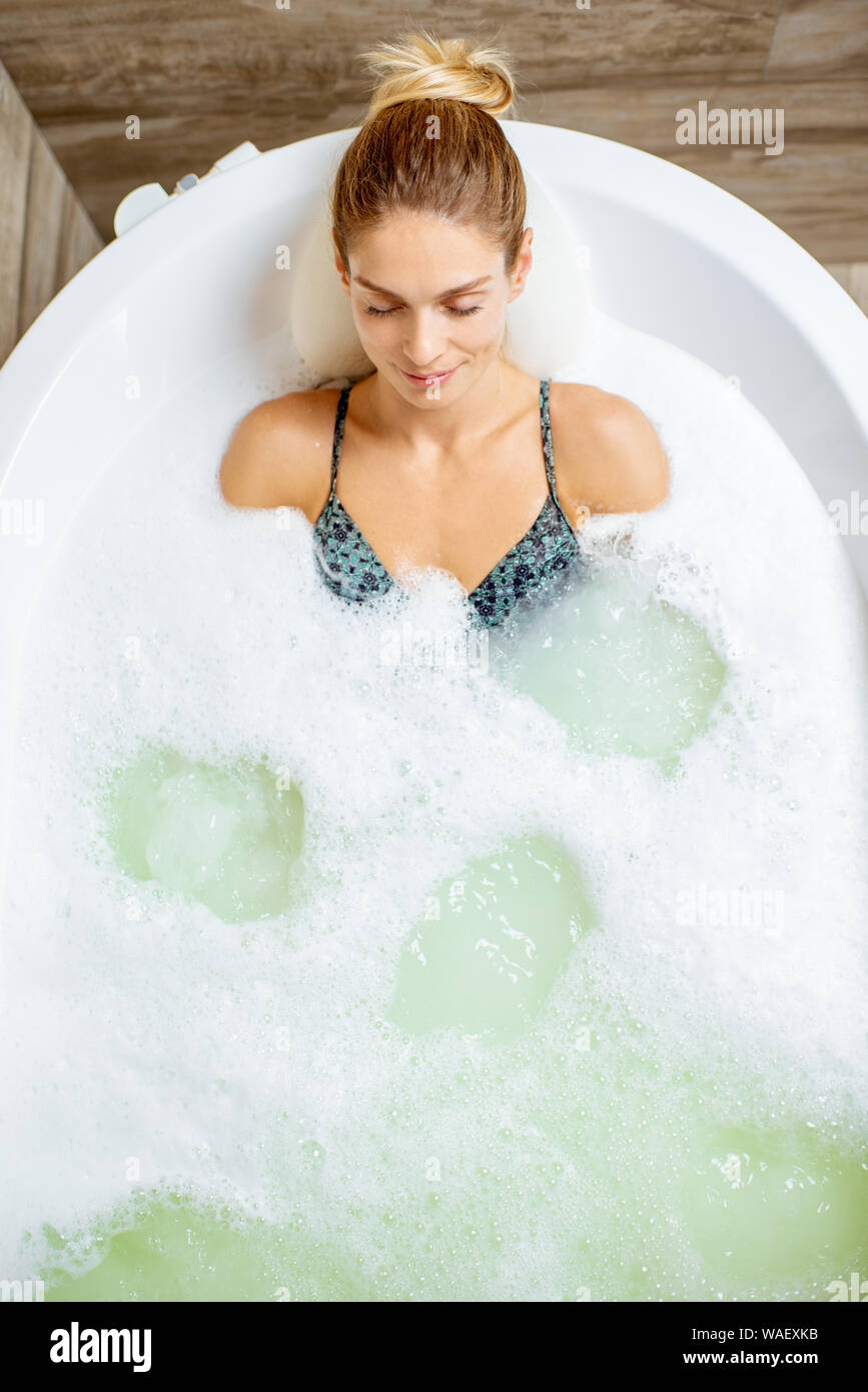 Beautiful Woman Relaxing In The Bathtub Having A Hydromassage Therapy