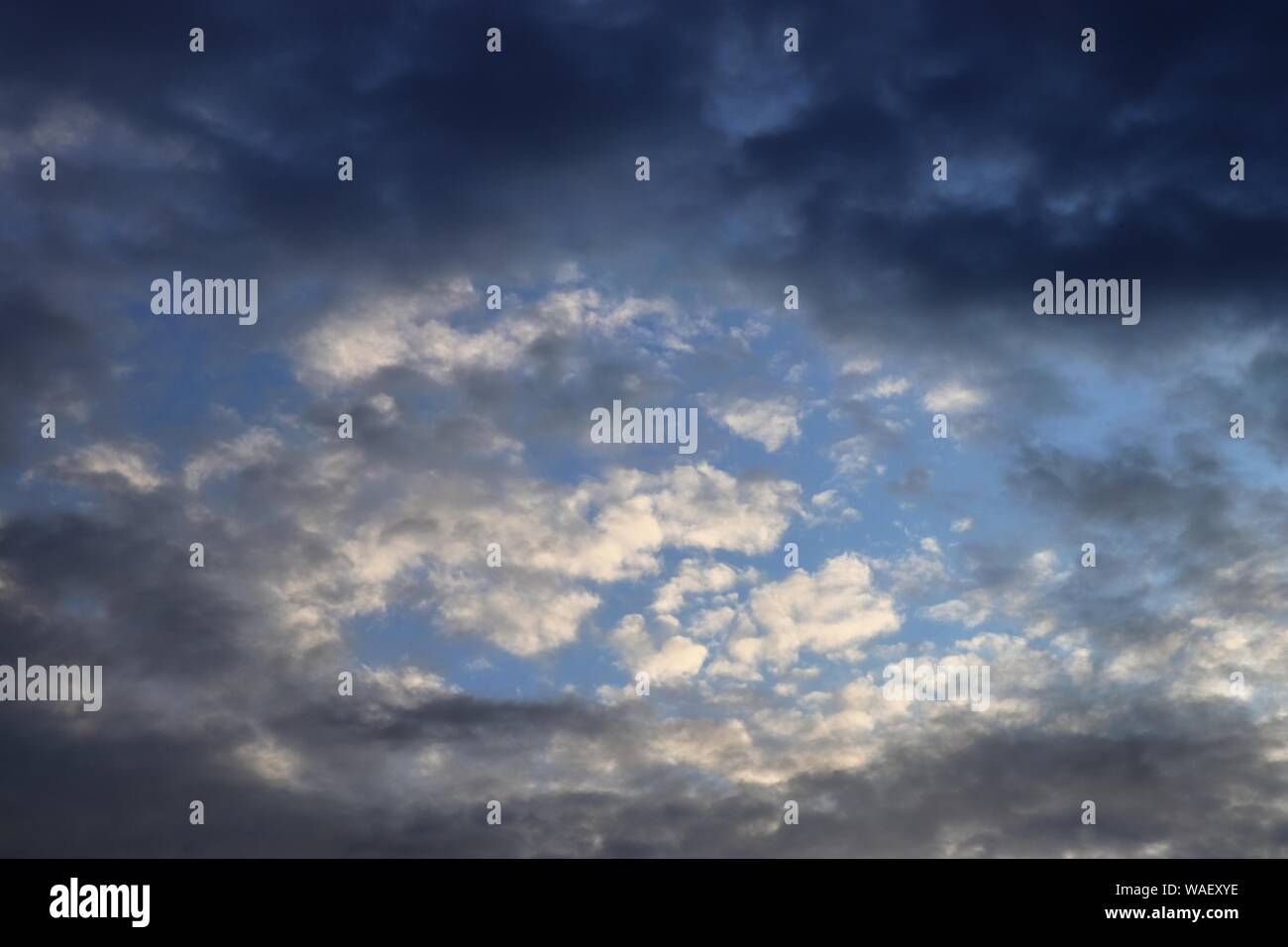 Beautiful view on panoramic orange sunset clouds on a deep blue sky Stock Photo - Alamy
