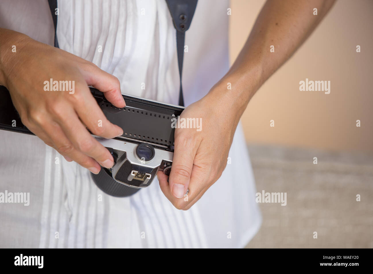 Contrast between old and modern times: a young woman fiddles with her ...