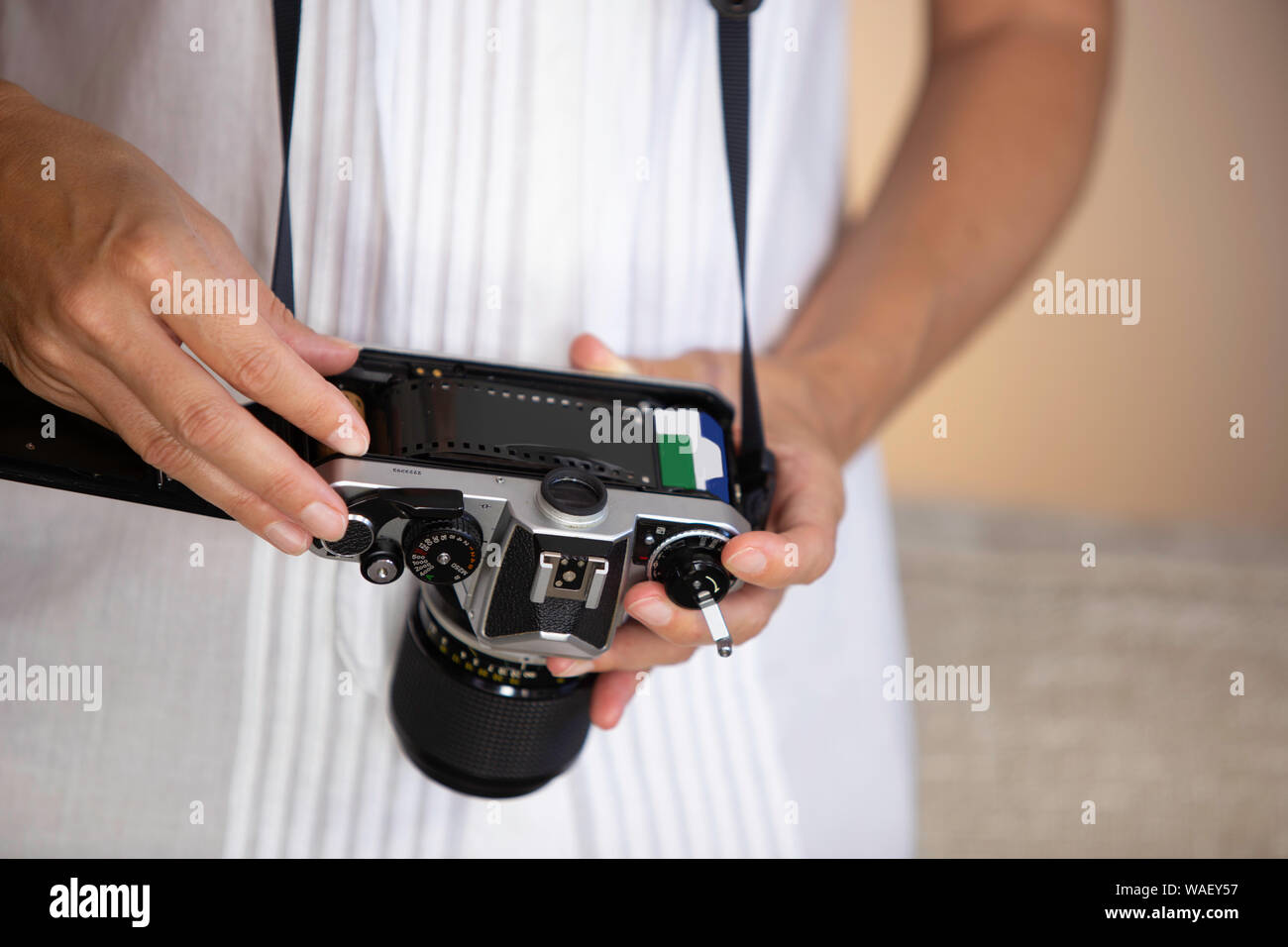 Contrast between old and modern times: a young woman fiddles with her ...