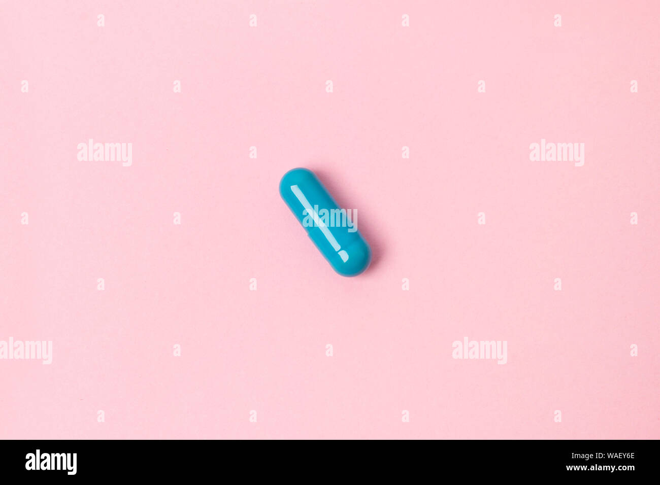 Blue pill at pink background. Flat lay top view. Medicine health ...