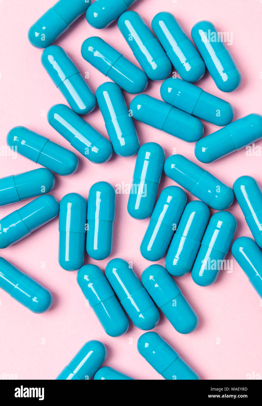 Blue pills at pink background.Flat lay top view. Medicine health ...