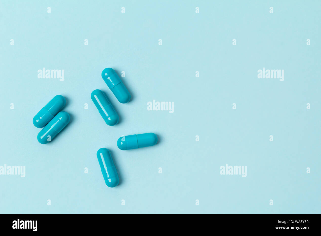 Blue pills on pastel background. Template for feminine beauty blog ...