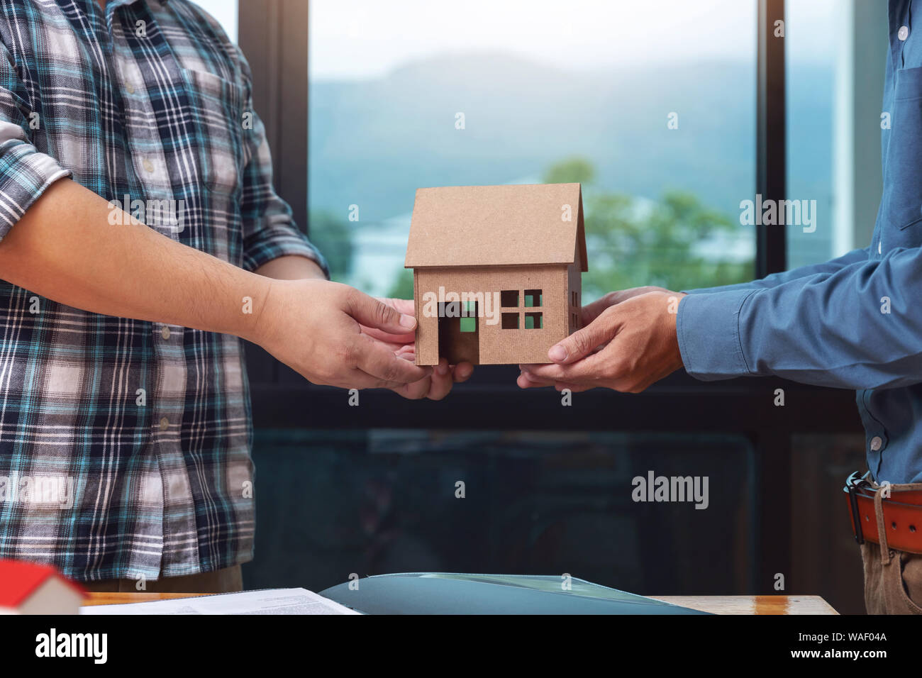 Real estate agent showing his client about property detail Stock Photo ...