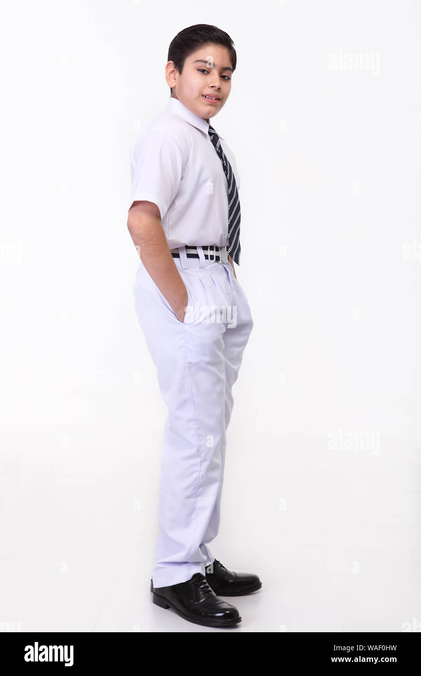 Schoolboy standing with his hands in pockets Stock Photo - Alamy