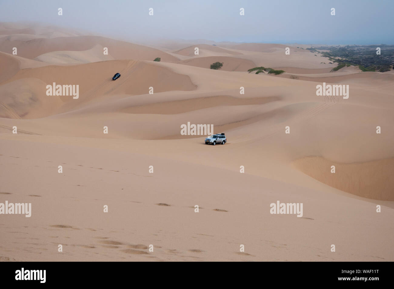 4x4 vehicles cross the dunes above Sandwich harbour in Namibia Stock ...