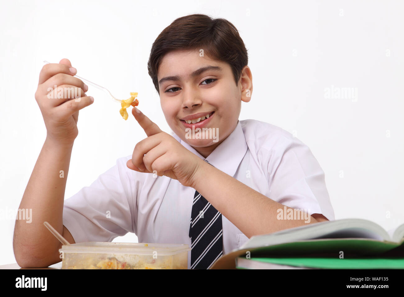 Boy eating and pointing hi-res stock photography and images - Alamy
