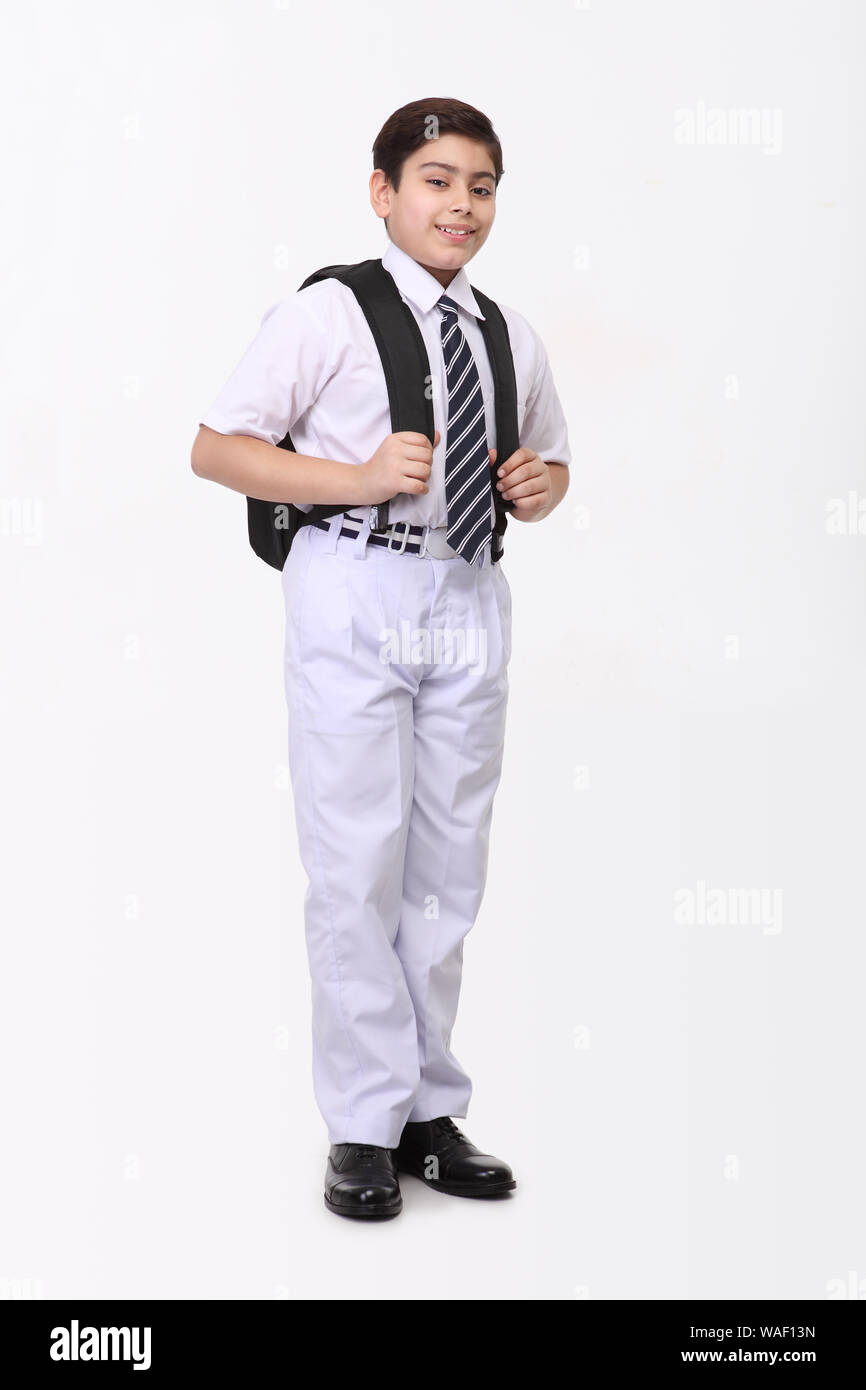 Schoolboy standing with backpack Stock Photo - Alamy