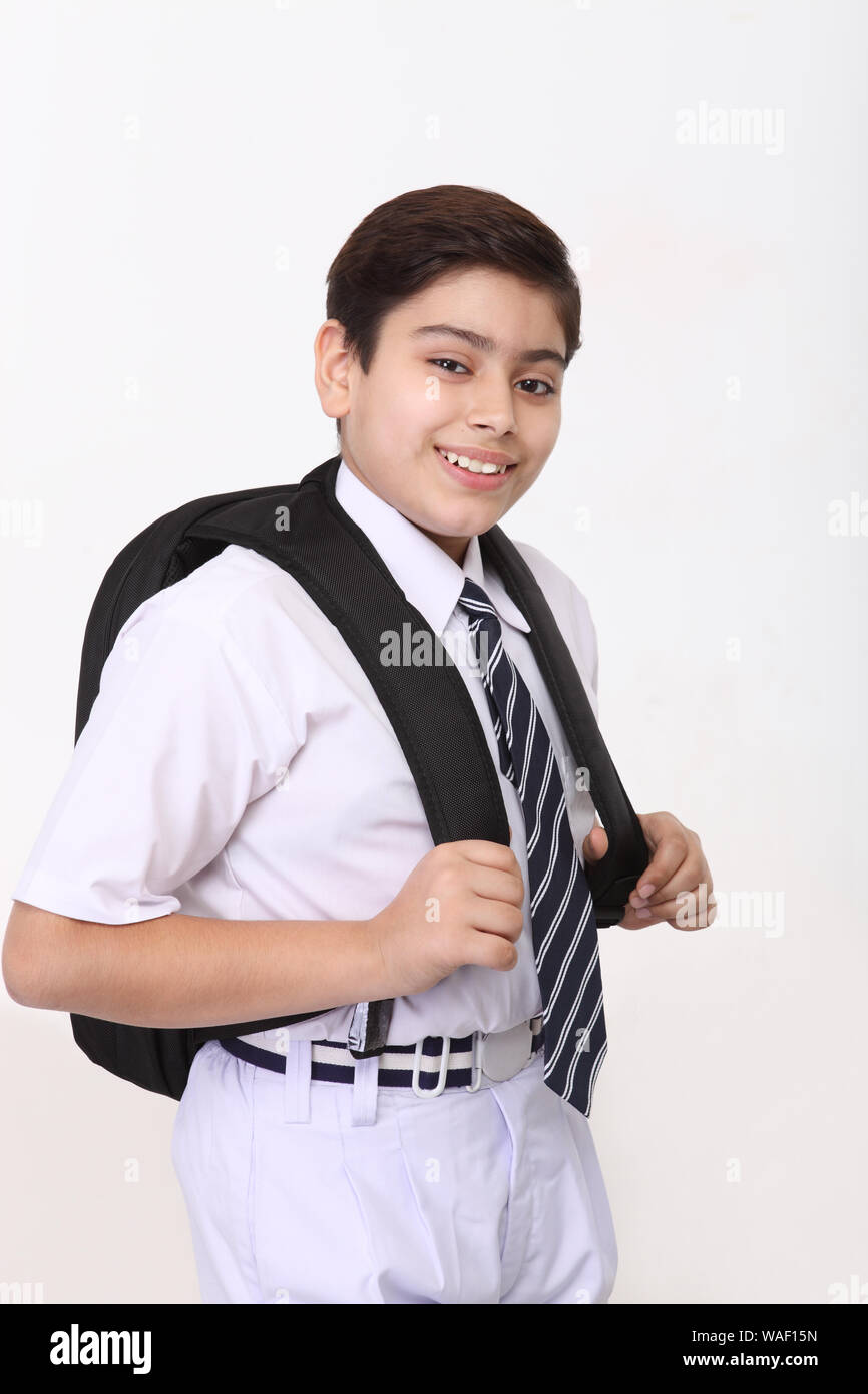 Indian schoolboy standing with backpack Stock Photo - Alamy