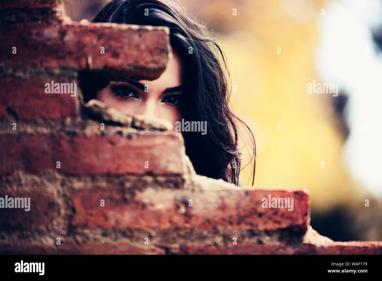 Beautiful Young Woman peeking Stock Photo - Alamy