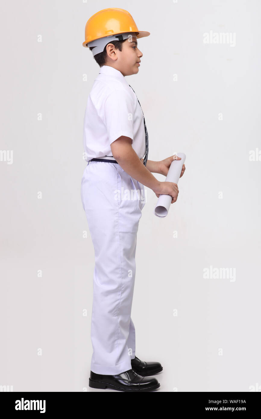 Indian boy pretending to be an architect and holding a blueprint Stock ...