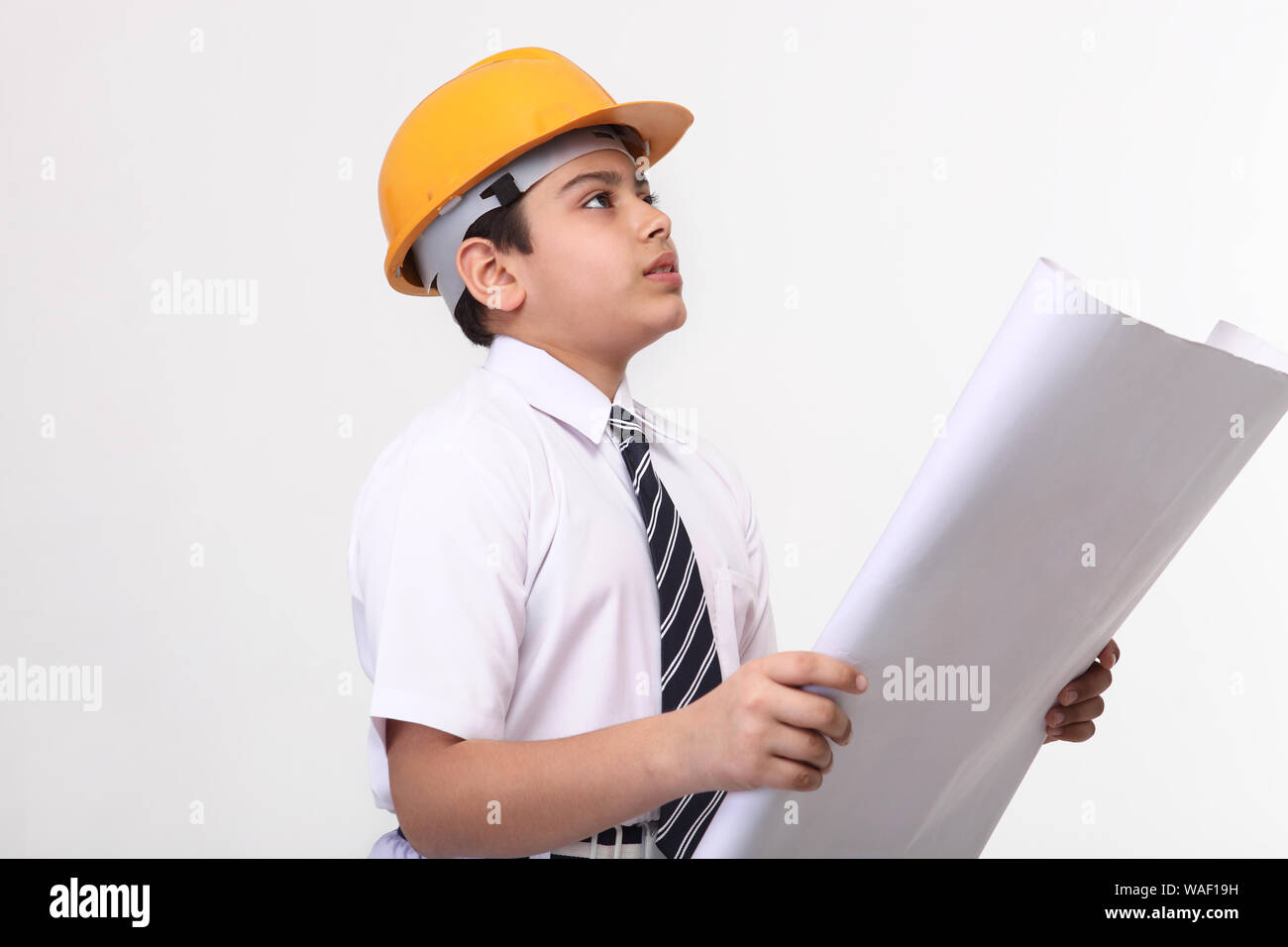 Boy pretending to be an architect and holding a blueprint Stock Photo ...