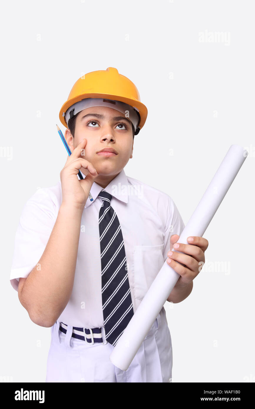 Boy pretending to be an architect and holding a blueprint Stock Photo ...
