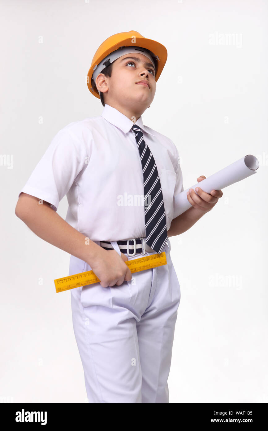 Boy pretending to be an architect and holding a blueprint Stock Photo ...