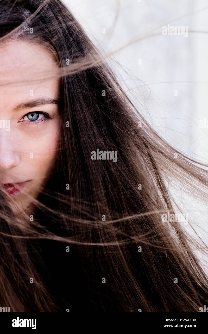 Beautiful Young Woman with hair flying over face Stock Photo - Alamy
