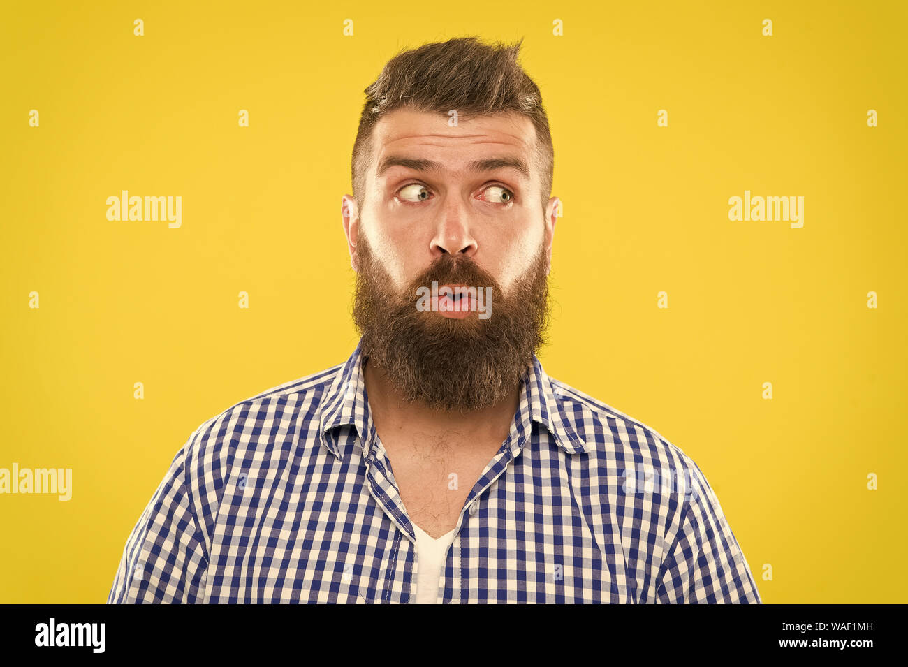 Man bearded hipster wondering face yellow background close up. Guy ...
