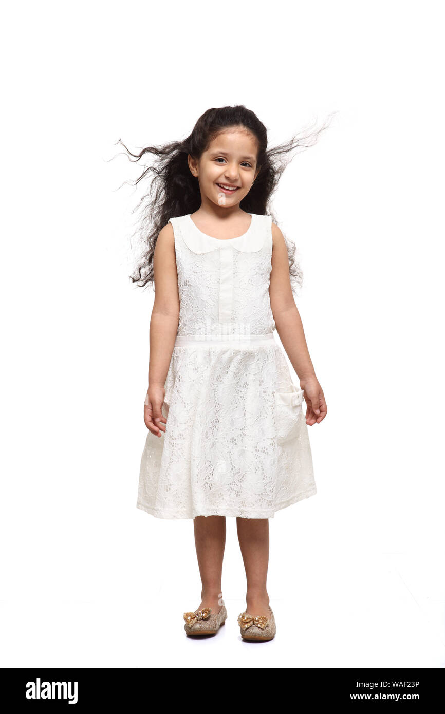 Girl standing and smiling Stock Photo - Alamy