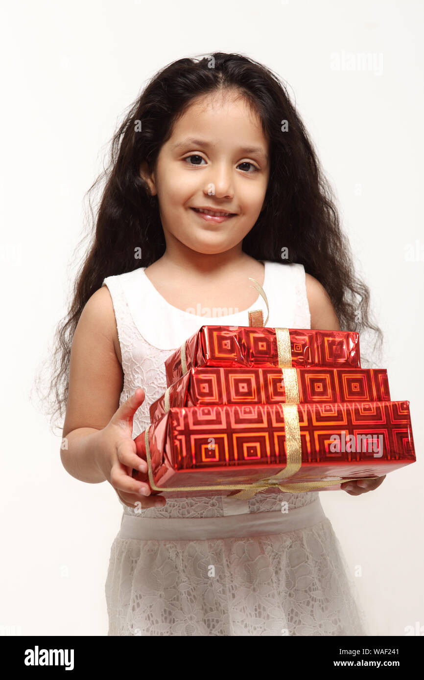 Girl holding gift boxes and smiling Stock Photo - Alamy