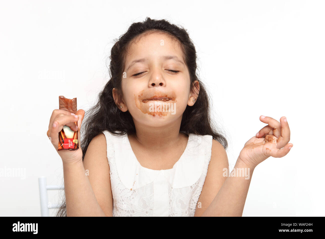 Girl eating a chocolate bar Stock Photo - Alamy