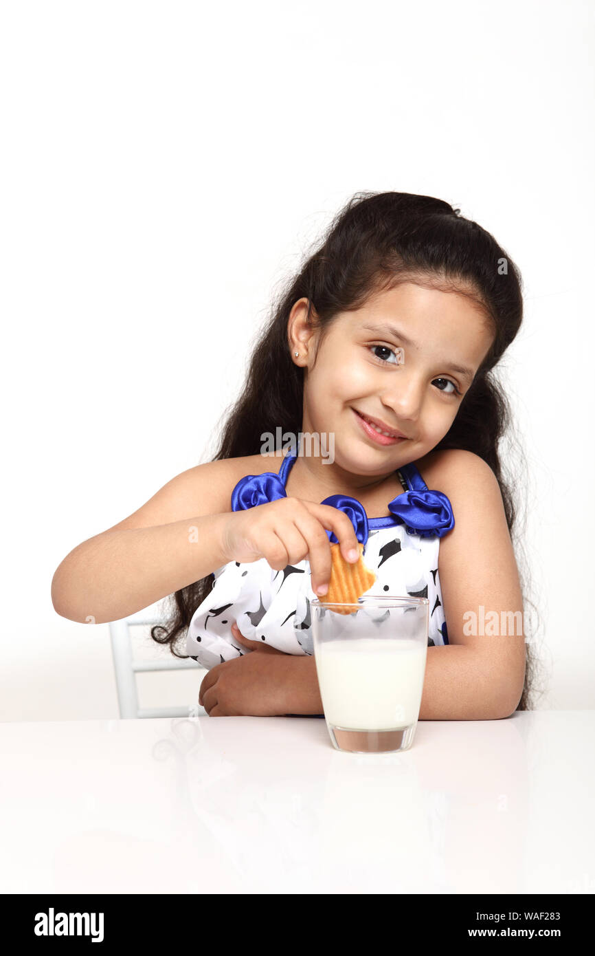 Girl eating biscuit Cut Out Stock Images & Pictures - Alamy