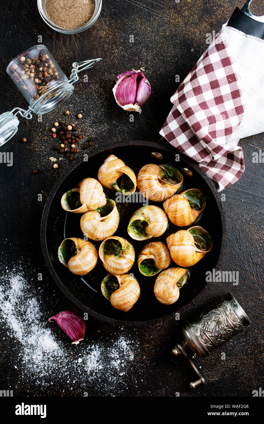 Snails baked with sauce, Baked snails with butter and spice Stock Photo ...